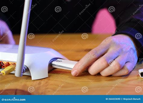 Inserting The Gsm Modem Into The Router On The Table By The Person