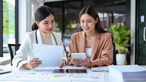Gorgeous Asian Female Executive Manager Working With Her Young Female