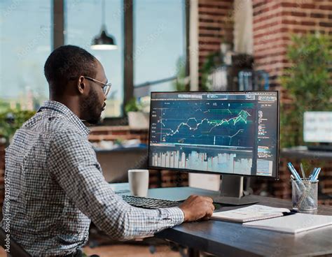 Analyst Works On Personal Computer Showing Business Analytics Dashboard With Charts Metrics And