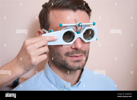 Adorable Bearded Male Is Checking His Visual Acuity Is The