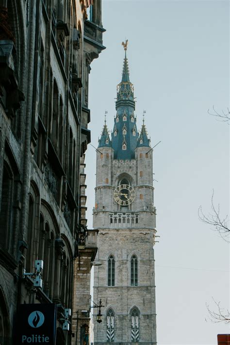 A Tall Clock Tower Towering Over A City Photo Free Grey Image On Unsplash