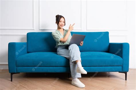 Premium Photo Image Of Young Asian Girl Sitting On Sofa At Home