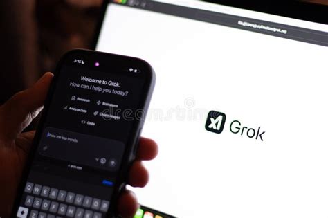 Tech Guy Trying Out Grok Mobile Phone Laptop Screen Showing Logo