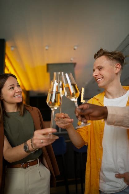 Free Photo Group Of Friends Cheering With Wine Glasses At A Restaurant
