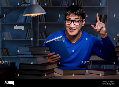 Student Preparing For Exams Late At Night In Library Stock Photo Alamy
