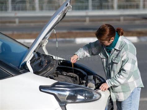 Caucasian Female Driver Checking Oil Level In Car Engine Stock Photo Image Of Measuring
