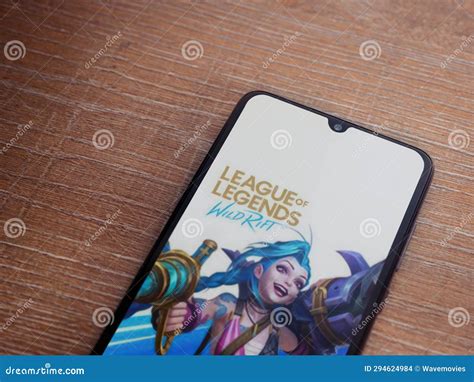 League Of Legends Wild Rift App Launch Screen On Smartphone On Wooden