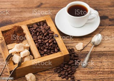 나무 배경에 빈티지 상자에 지팡이 설탕과 콩과 지상 분말 신선한 원시 유기농 커피의 흰색 컵 맨 위 보기 0명에 대한 스톡 사진