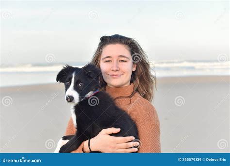 Pretty Portrait Of A Young Woman And Her Young Border Collie On The