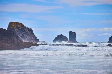 premium photo dynamic sea stacks and ocean waves under clear sky wide