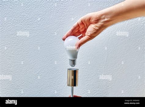 Replacing An LED Light Bulb In Household Lighting Fixture For Home Stock Photo Alamy