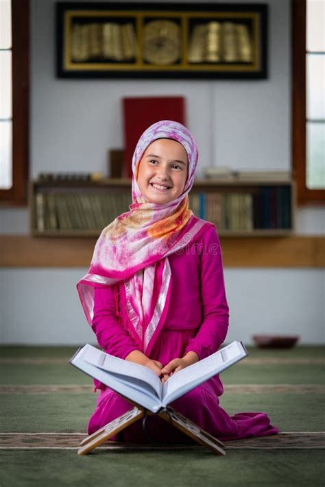 A Happy Muslim Girl Reading A Holy Book Quran Inside The Mosque Stock