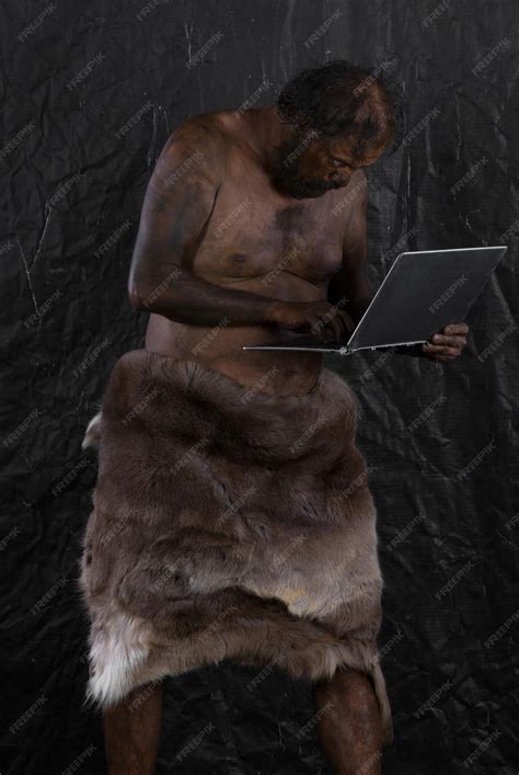 Premium Photo Caveman With Laptop Neanderthal Man With Computer