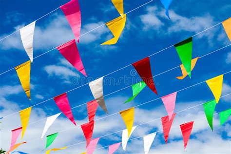 Colorful Triangular Flag Line Moving By Wind On Blue Sky White Cloud