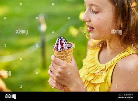 Happy Girl With Braces Eating Italian Ice Cream Cone Smiling While