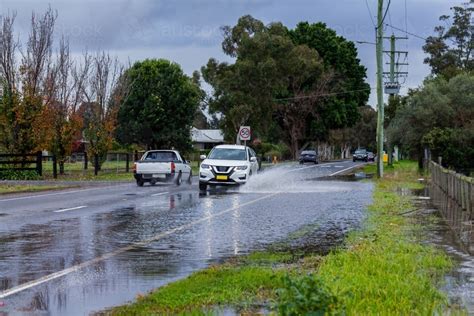 Image Of Flood Water Forming Puddle On Highway Road Through Town With