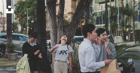 Man In White Button Up Shirt And Black Pants Standing Beside Man In