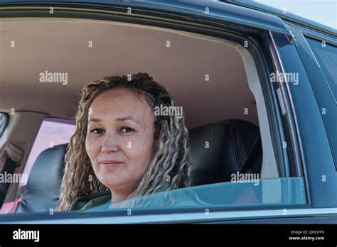Close Up Portrait Of Cute Smiling Middle Aged Asian Woman In Open Car