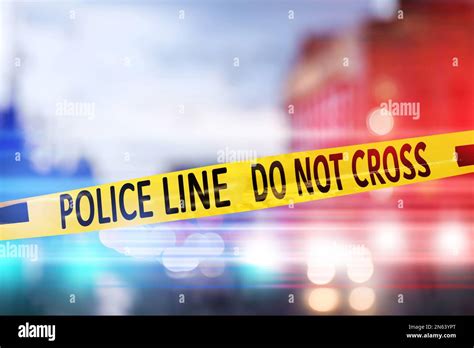 Yellow Law Enforcement Tape Isolating Crime Scene Blurred View Of City