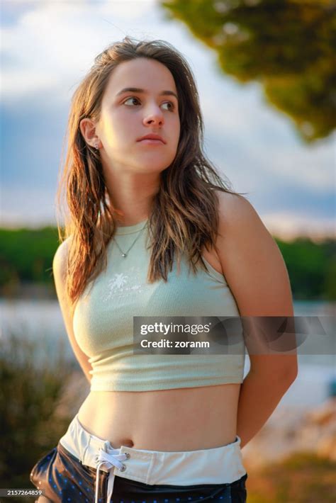 Portrait Of Cute Teenage Girl In Crop Top Standing On The Coast And