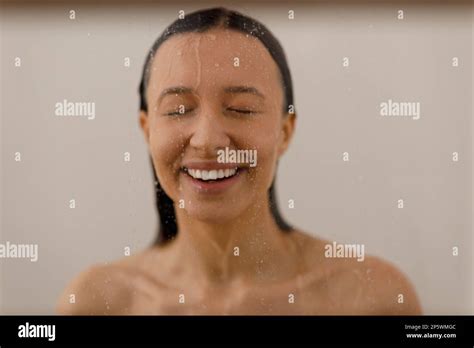 Young Woman Under The Trickles Of Water In Pleasure Shower Beautiful
