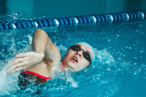 Successful Female Swimmer Swimming In The Pool A Professional Athlete