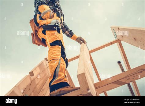 Contractor Finishing Newly Built House Wooden Skeleton Frame