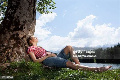 A Woman Lying Under The Tree Photos And Premium High Res Pictures