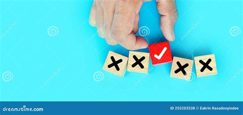 Hand Choose Check Mark On Cube Wooden Toy Block Stack With Cross Symbol