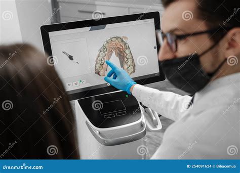 Male Doctor Show Results Of Digital Intraoral Scan Of Patient Teeth In