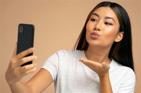 Premium Photo Joyful Asian Young Woman Using Smartphone For Video