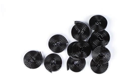 Black Liquorice Candies On A White Background Premium Photo