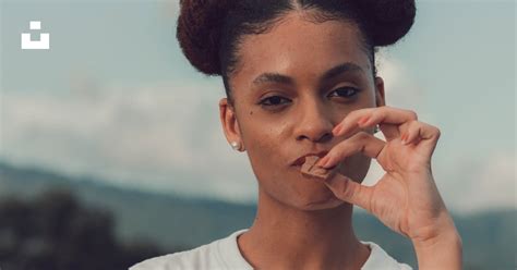 A Woman Sitting On A Rock Smoking A Cigarette Photo Free Portrait