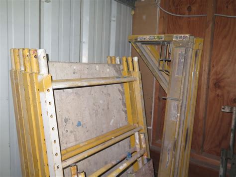 Multiple Metal Yellow Scaffolding Sections And Bucket Wheel Casters