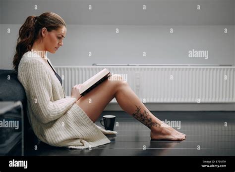Side View Of Beautiful Young Lady Reading A Book Caucasian Female
