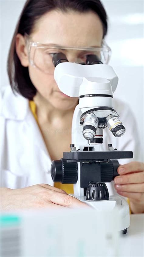 Woman Scientist Using Microscope In Laboratory Microbiology Science