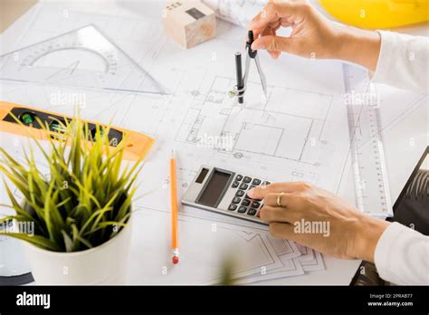 Architect Drawing With Divider Compass On House Plan Blueprint Paper