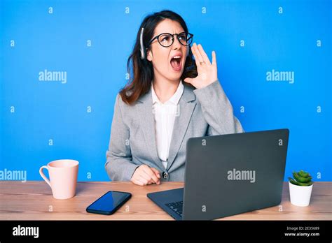 Young Beautiful Brunette Woman Working At The Office Wearing Operator