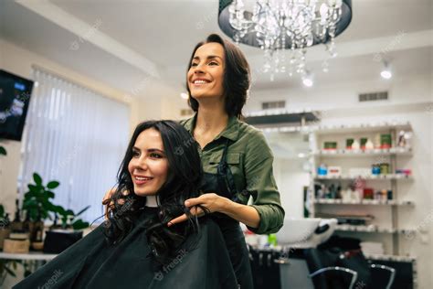 Premium Photo Close Up Photo Of A Female Hairstylist Who Is Touching The Hair Of Her Happy