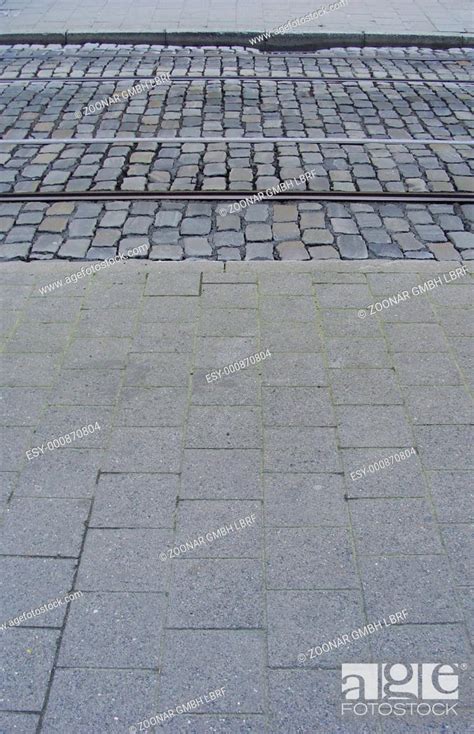 Sidewalk And Street With Tram Rail Embedded In Cobble Stone Stock