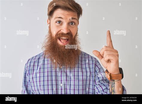 Redhead Irish Man Listening To Music Using Wireless Earphones Over