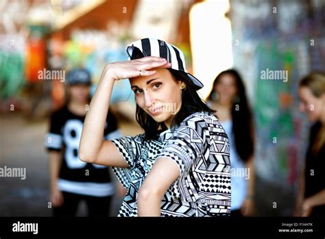 Young Woman Wearing Baseball Cap Backwards Looking At Camera Stock