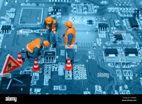Miniature Engineers Fixing Error On Chip Of Circuit Board Computer