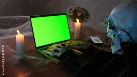 Skeleton Bony Hands Typing At Laptop Keyboard With Chromakey In Screen