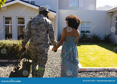 Rear View Of Multiracial Army Soldier In Camouflage Holding Wife S Hand