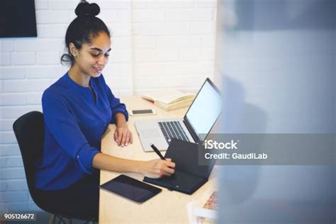 긍정적인 전문 기자 현대 기술을 사용 하는 동안 검정 교과서로 문서의 주요 아이디어를 기록 매력적인 웃는 여자 Coworking 화면 노트북을 모의로 공간에 앉아 Cd