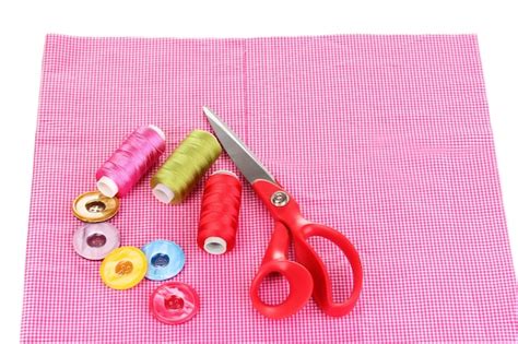 Premium Photo Scissors Buttons And Bright Threads On Fabric Isolated