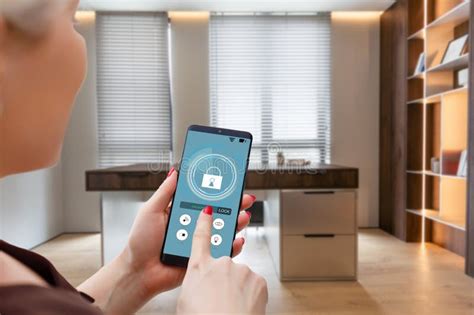 Smart Home Automation App On Smartphone Hold By Female Hand With Home Interior In Background