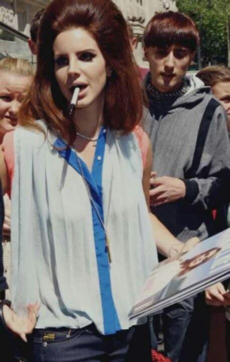 Lana Del Rey Signing Autographs With A Pen In Her Mouth Bouffant White