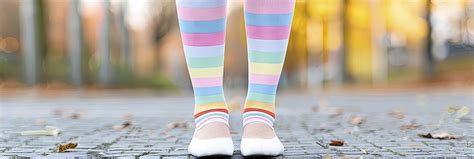 Close Up Of A Young Womans Legs In Rainbow Socks Standing On The Street